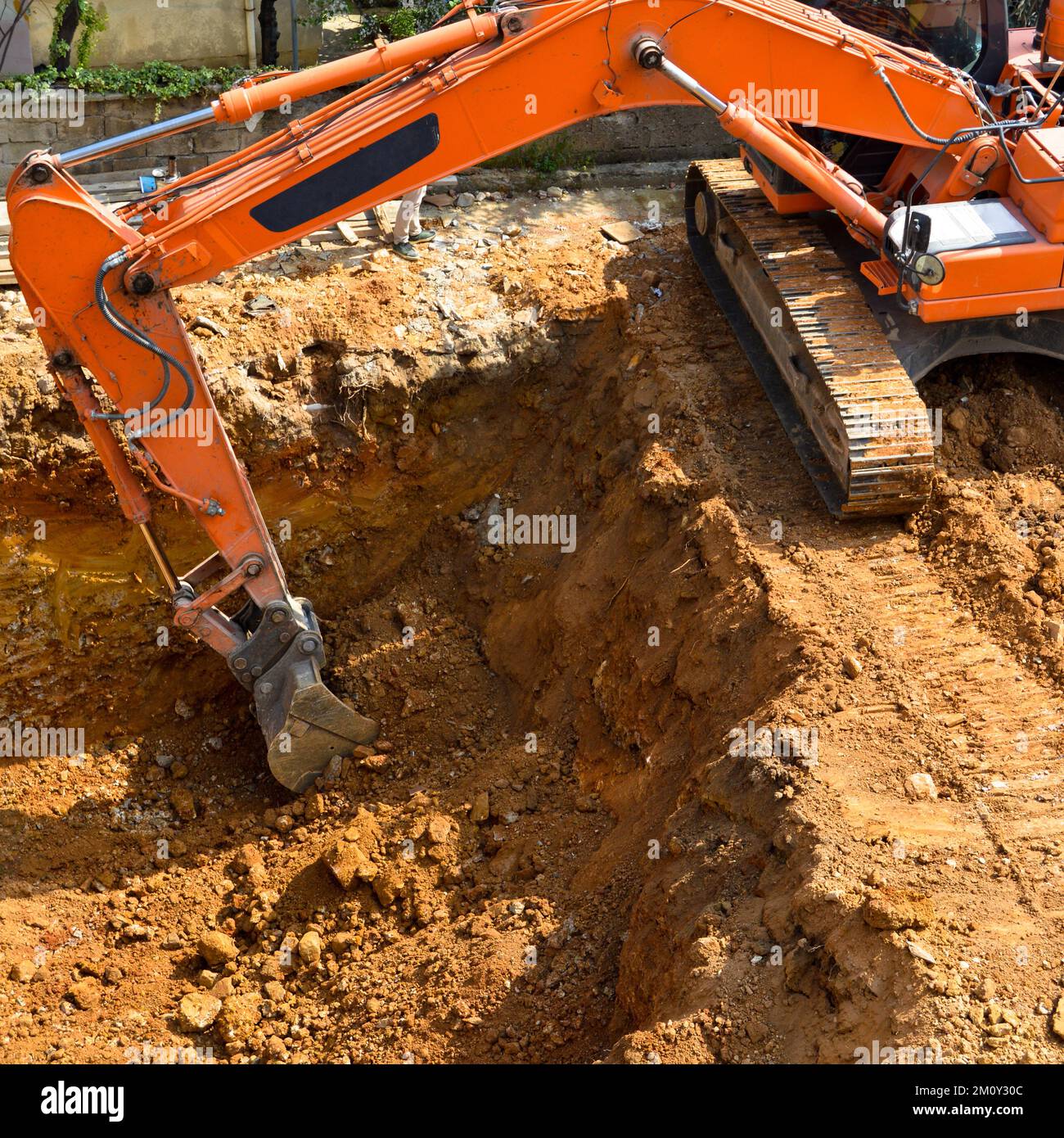Excavator continues to work at the construction site, excavation site and excavator Stock Photo ...
