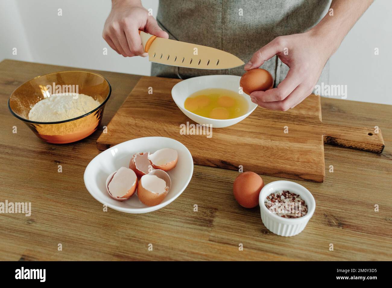 Cooking in progress. Eggs, flour, salt on the table, cutting board and ...