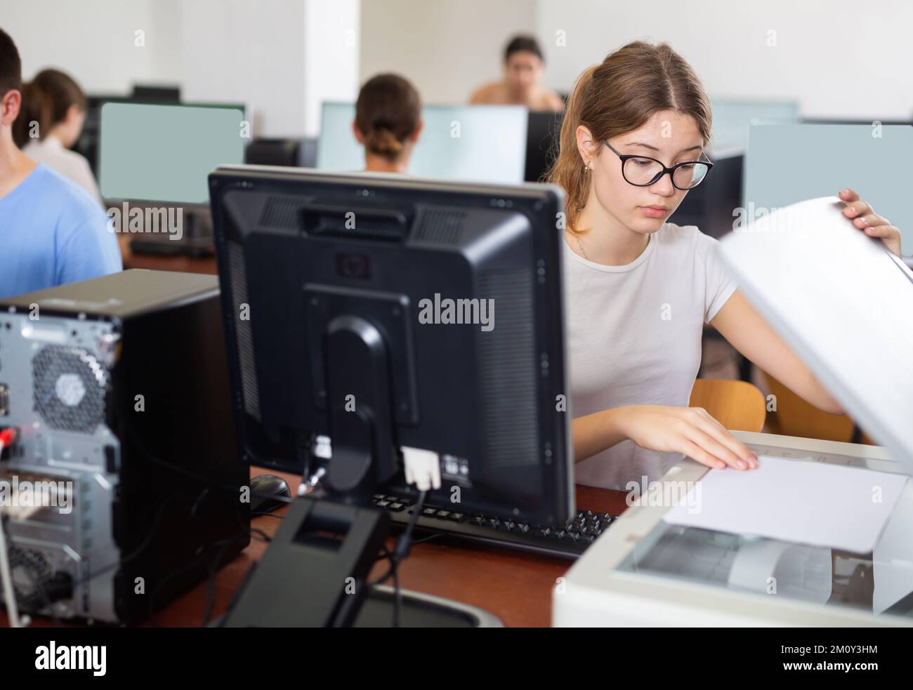Clever female teenager solving tasks of computer science, using pc and ...