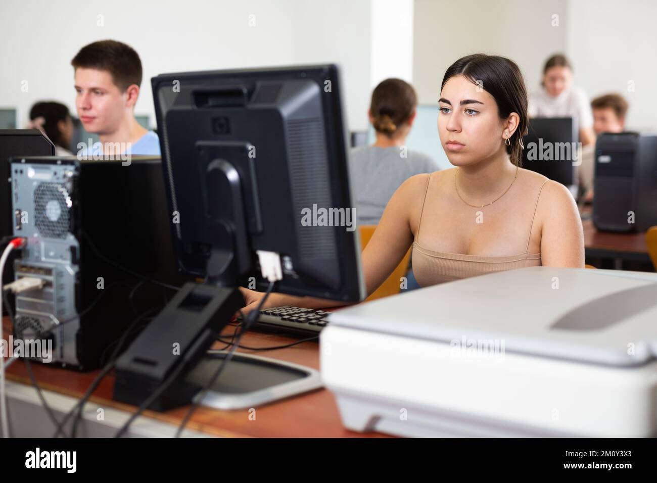 Teenage girl learning to use personal computer during lesson Stock ...
