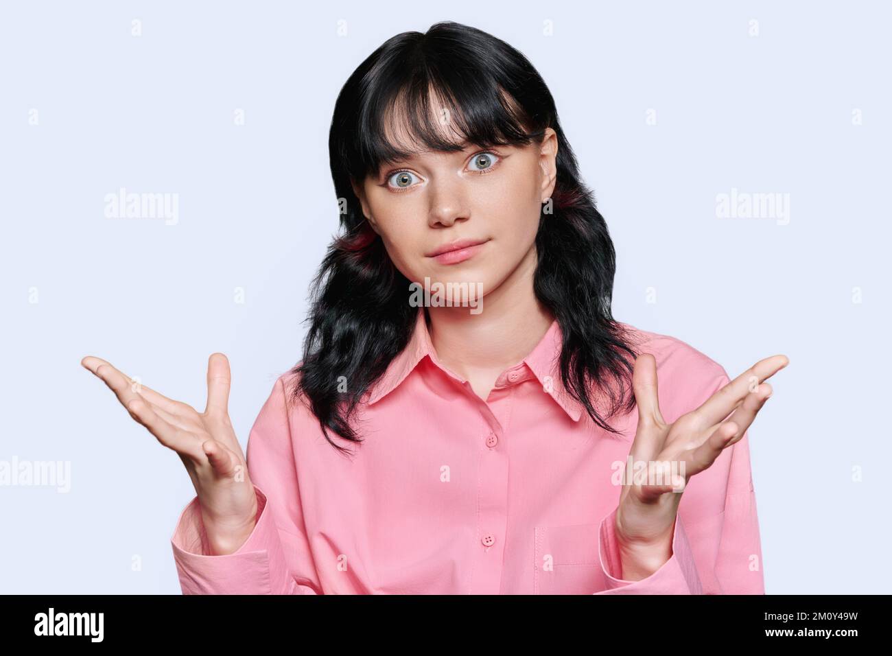Surprised teenage female student looking at camera on white background ...