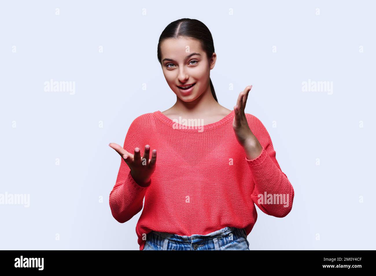 Emotional laughing young female student on white background Stock Photo ...