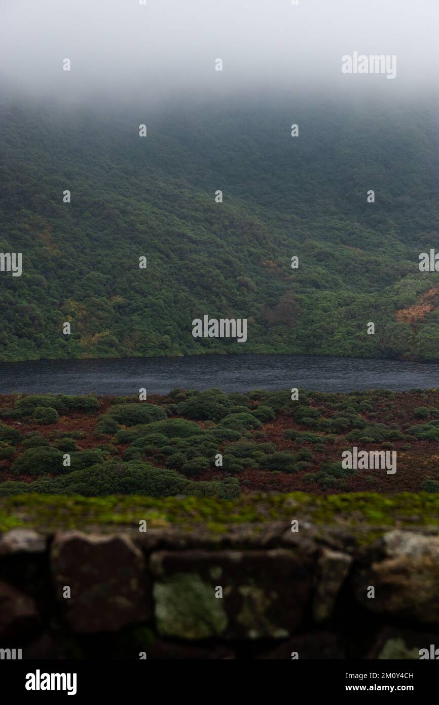 Lake in the mountains with low clouds passing by. The Bay Lough ...