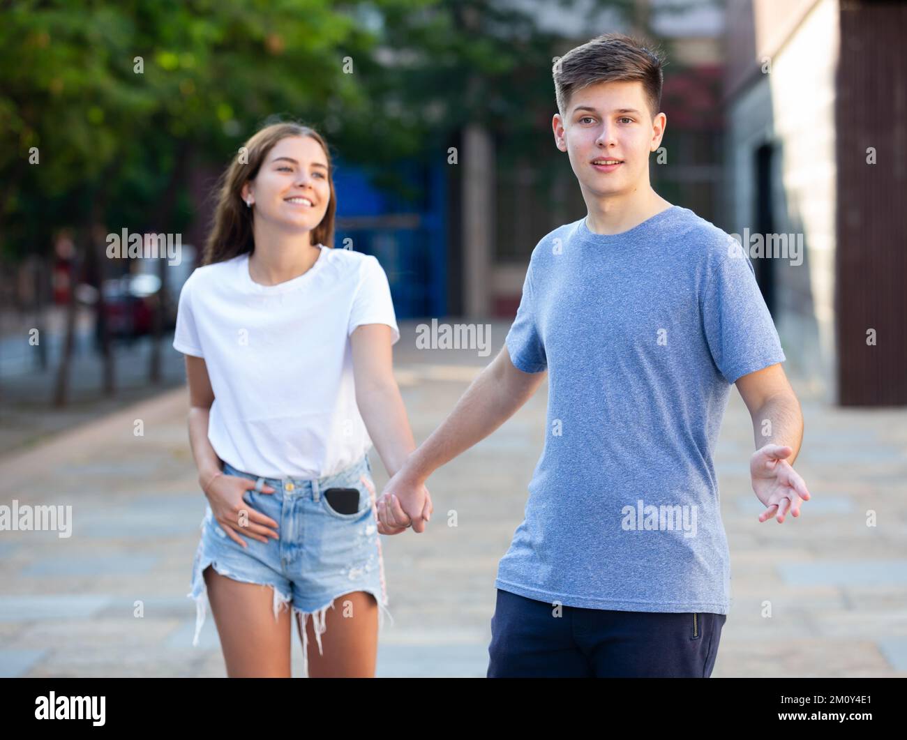 Two teenagers are talking about play on walk on street Stock Photo - Alamy