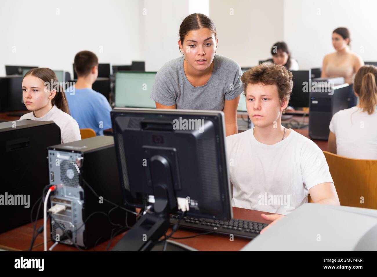 Schoolboy and teacher using PC in computer class Stock Photo - Alamy