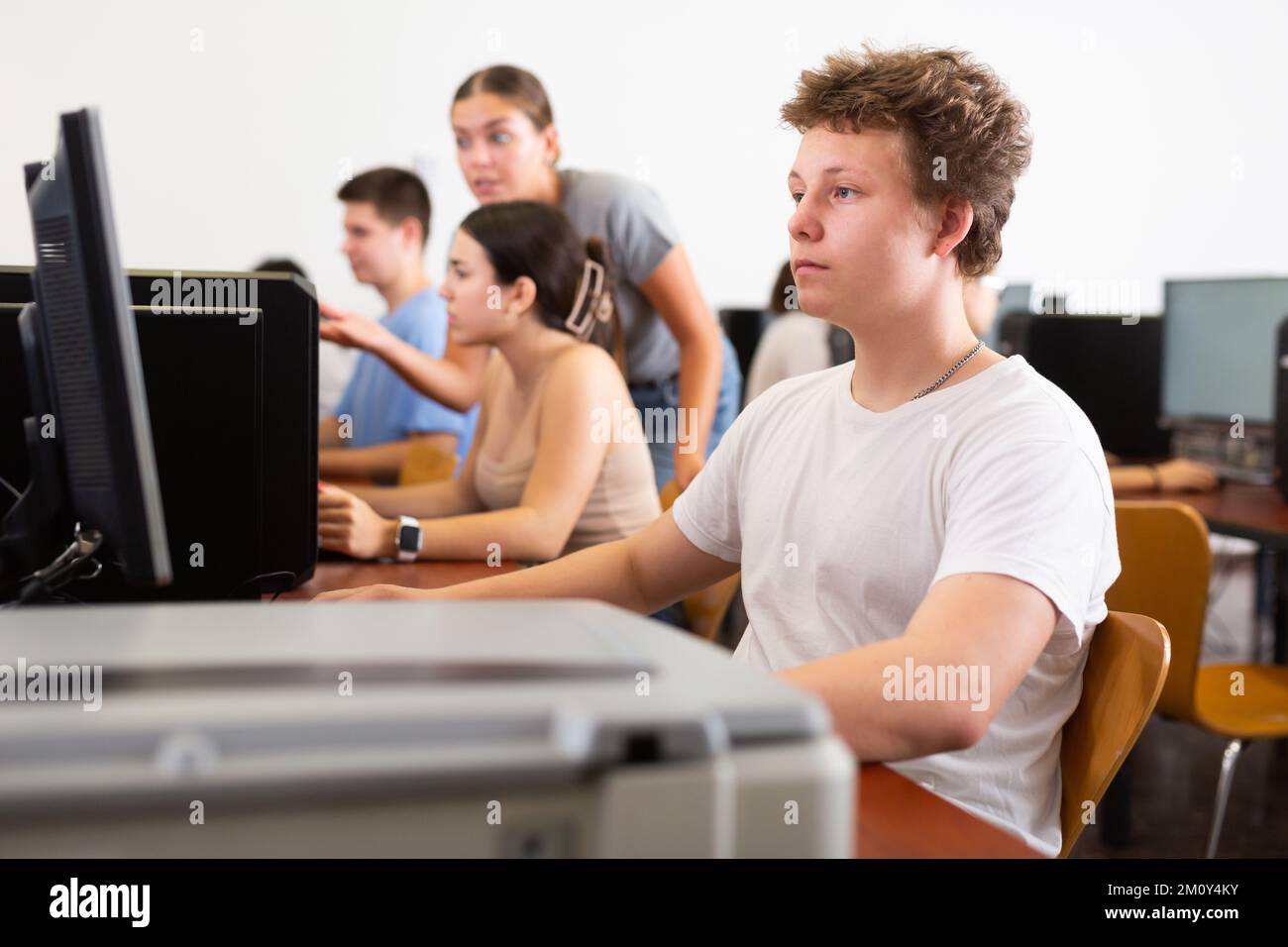 Teenager boy using PC during computer science lesson Stock Photo - Alamy