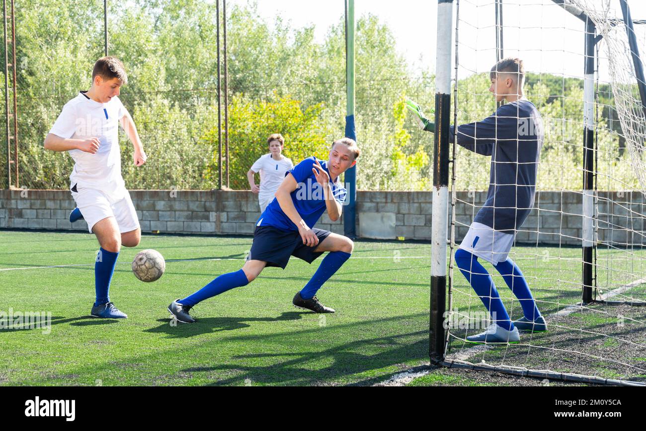 Teens playing soccer football match. Competition between two youth ...