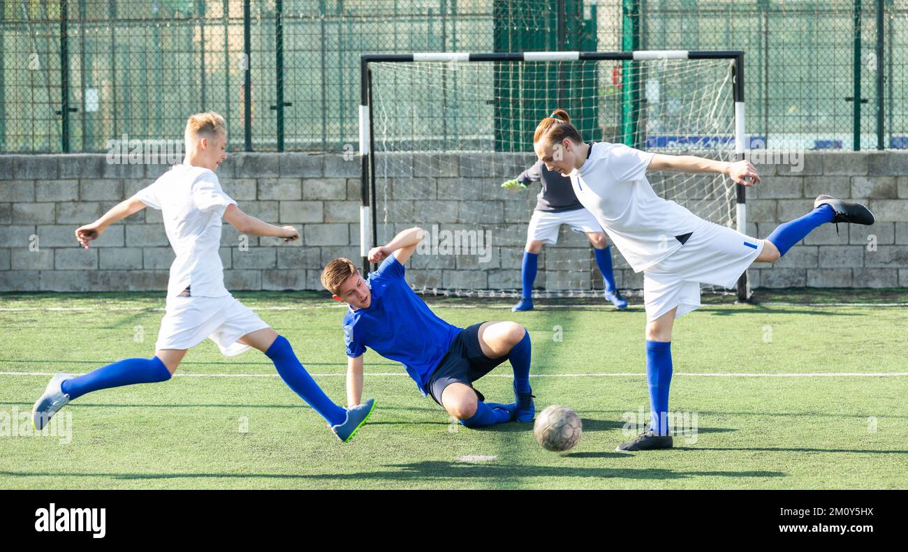Young football players fighting for ball Stock Photo - Alamy