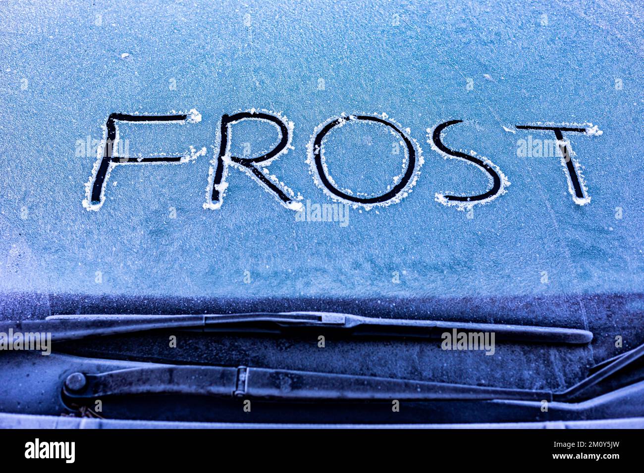 Frost written by hand on the windscreen of a car.The image shows the ...