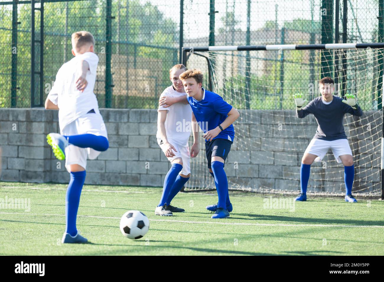 Young football players fighting for ball Stock Photo - Alamy