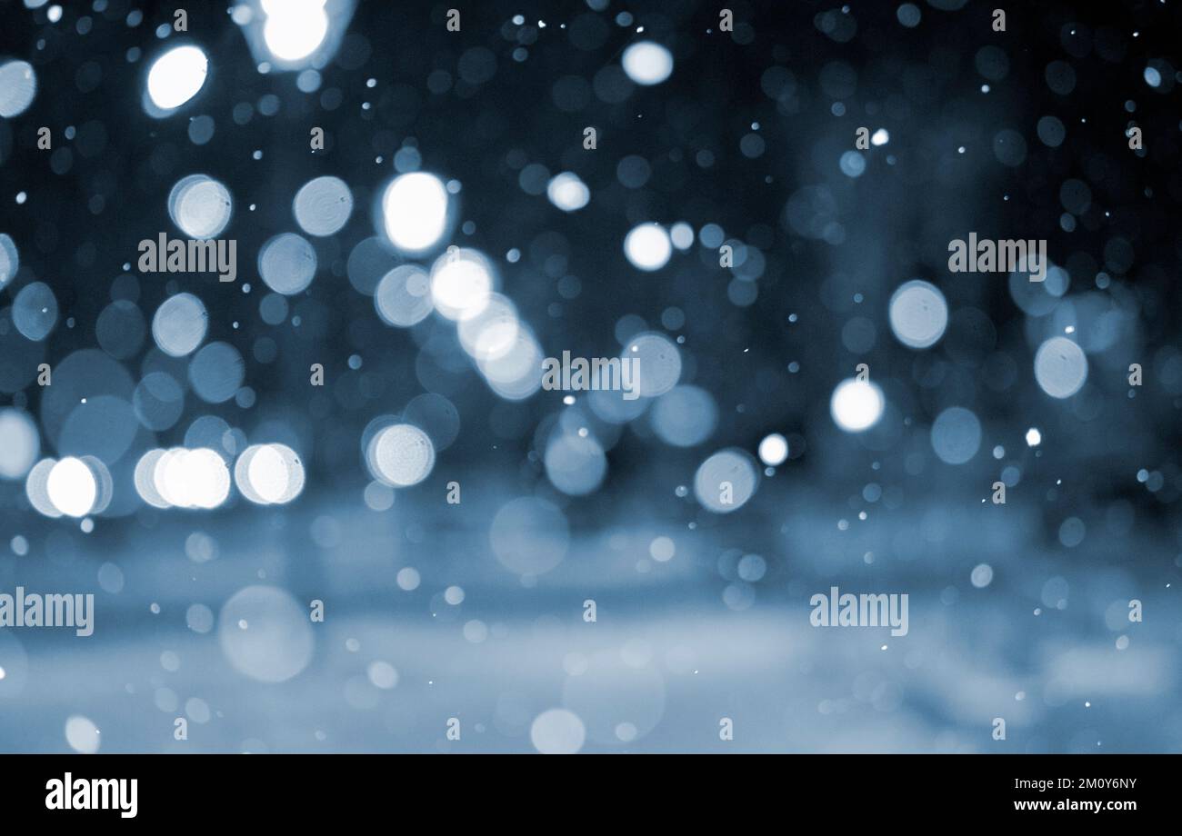 Blurred background. City view, lights, falling snow, night, street ...