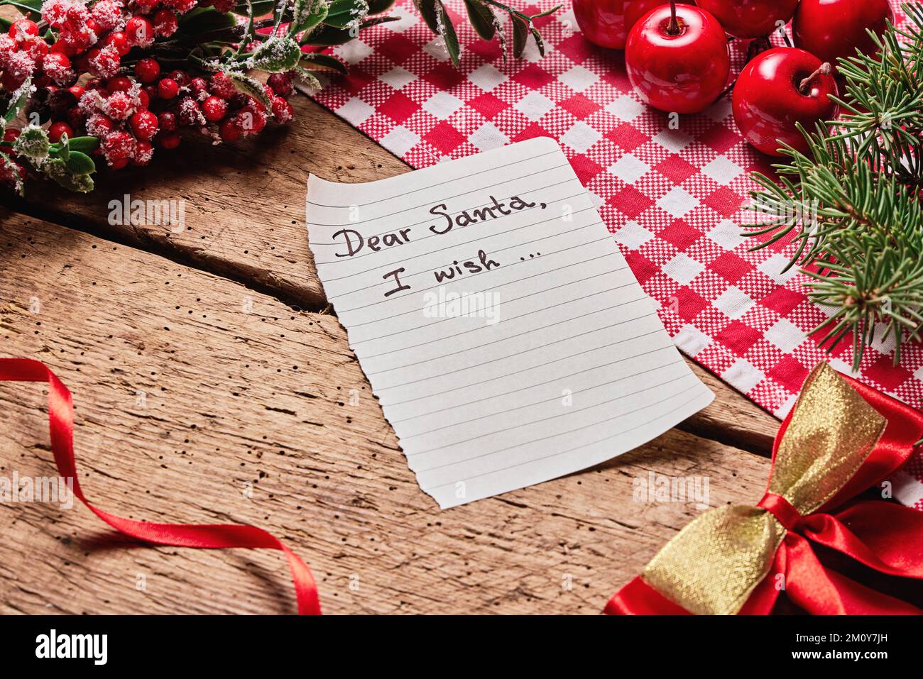 Dear Santa Claus wish card and letter on wooden desk with many colorful ...