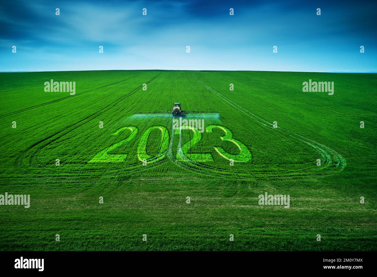2023 Happy New Year concept and Aerial view of farming tractor plowing ...