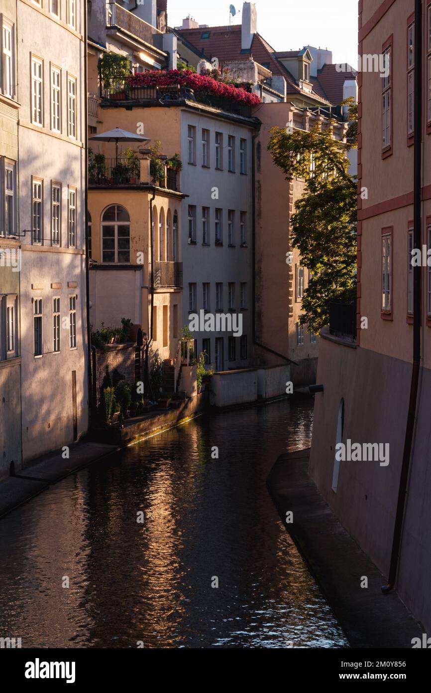 A vertical of the Certovka canal between buildings in Prague in the ...