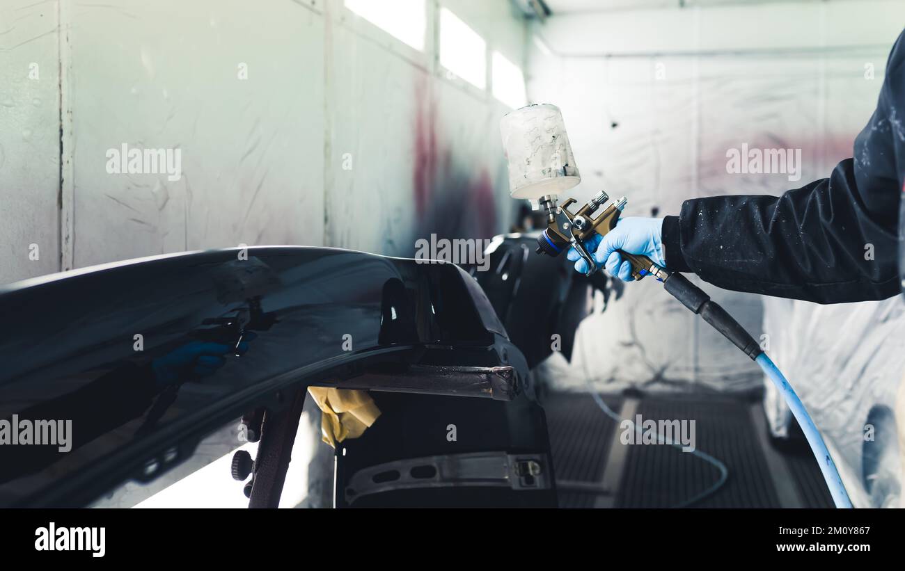 After accident car detailing. Fender varnishing. Arm holding paint ...