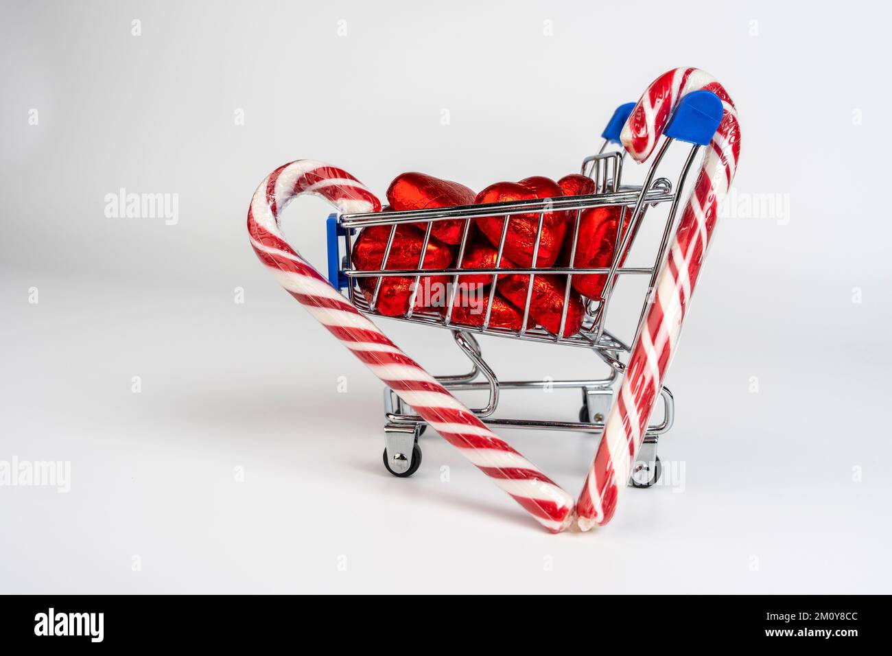 A supermarket trolley loaded with candies and Christmas caramel canes ...