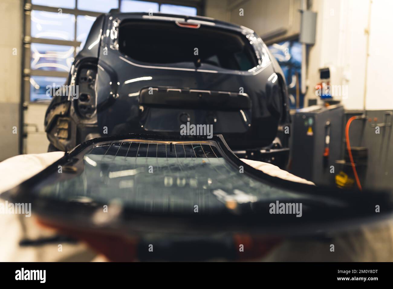 Blurred removed rear window in the foreground. Black car without a rear ...