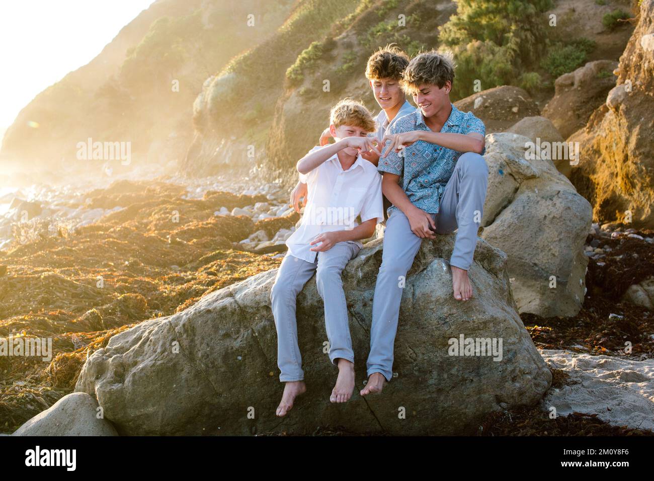 Oldest Brother Watches While Younger Two Make Heart Shaped Hands Stock ...