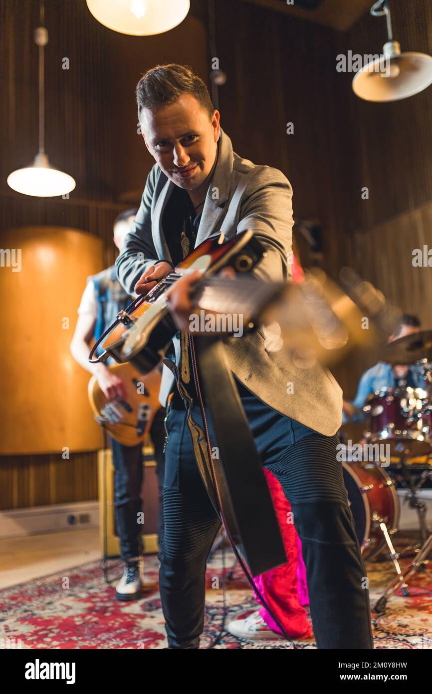 Man with an electric guitar during a music band performance. High ...