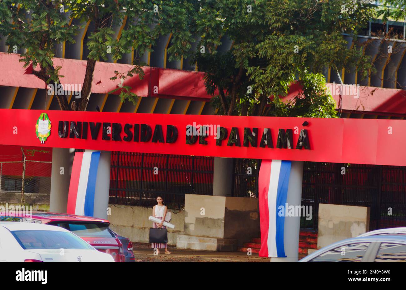 entrance to the university of panama with a student standing outside ...