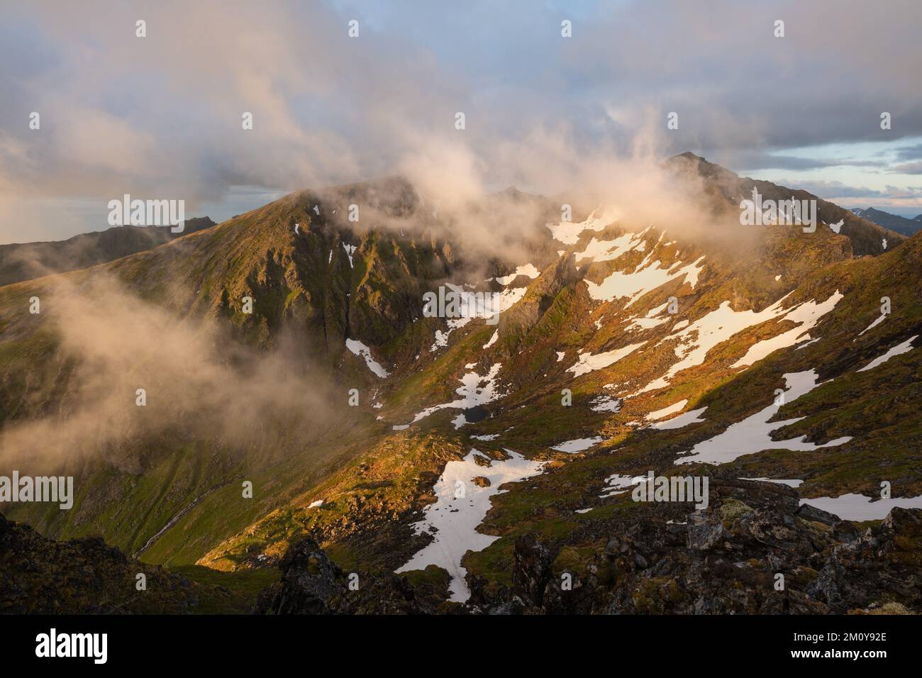 Misty clouds swirl around mountain peaks, Lofoten Islands, Norway Stock ...