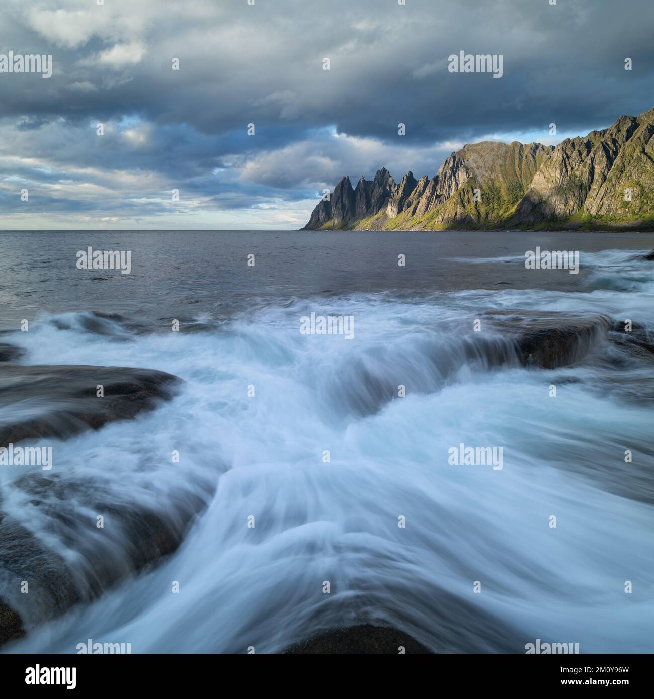 Waves flow over rocky shoreline at Tungeneset viewpoint, Senja, Norway ...