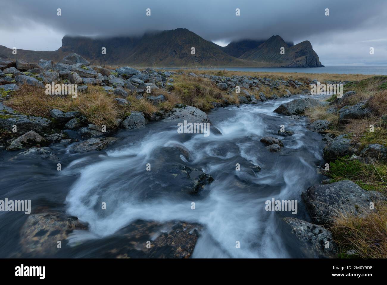 River Flowing towards sea, Unstad, Lofoten Islands, Norway Stock Photo ...