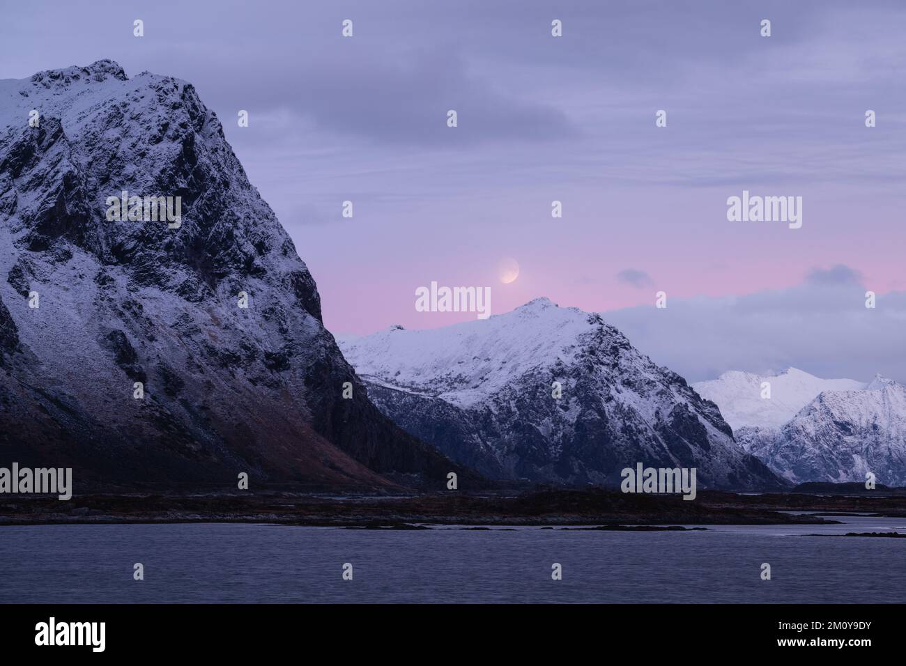 Moon over mountain peaks in December twilight, Lofoten Islands, Norway ...