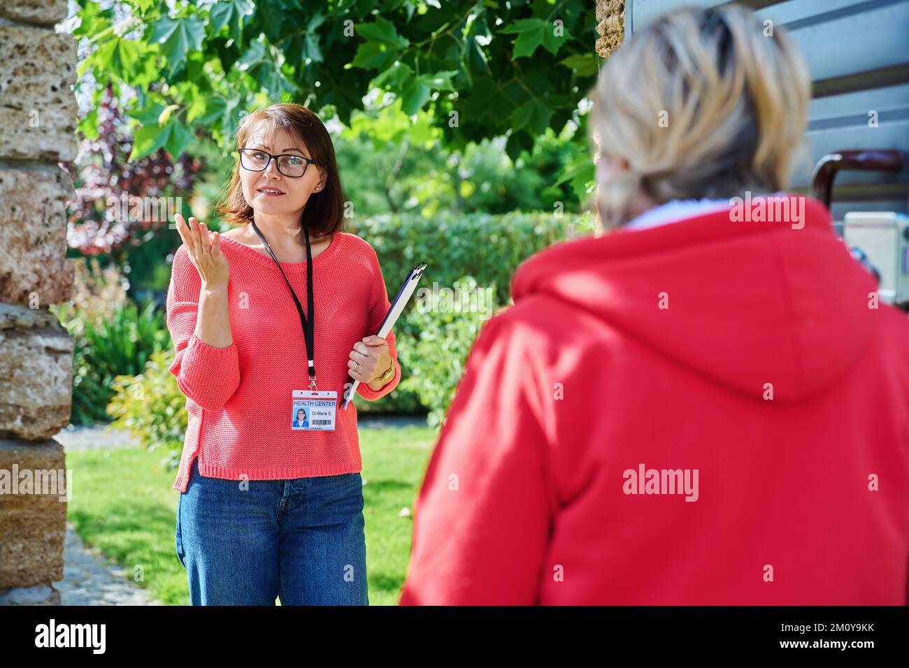 Female social counselor, health center worker, meets middle-aged woman ...