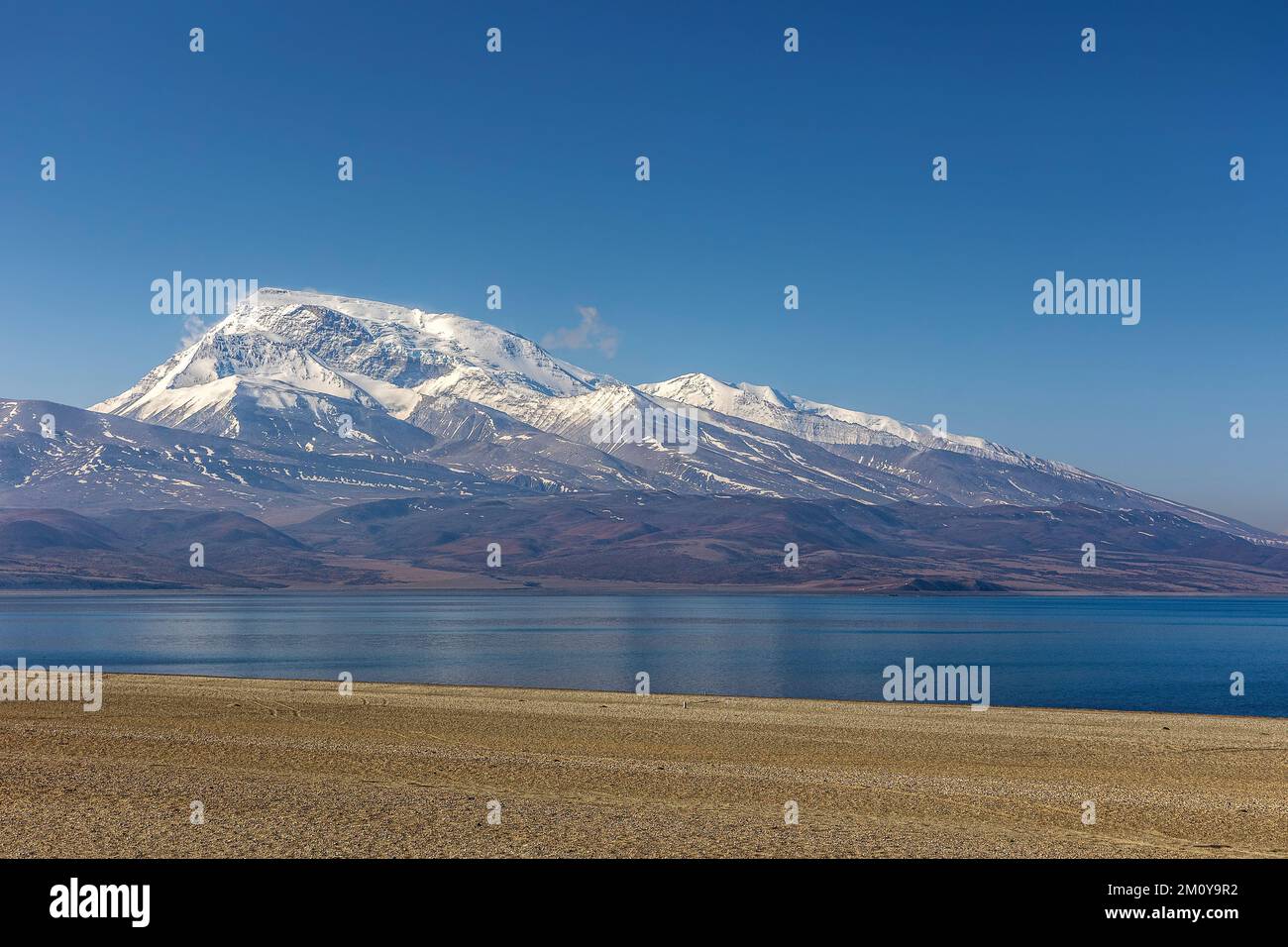 A beautiful lake with the snowy peak of Gurla Mandhata in Himalayas in ...