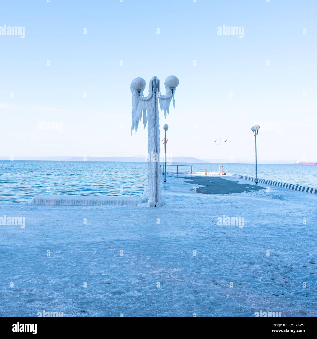 Frozen city after freezing rain. Vladivostok. The street lamp is frozen ...