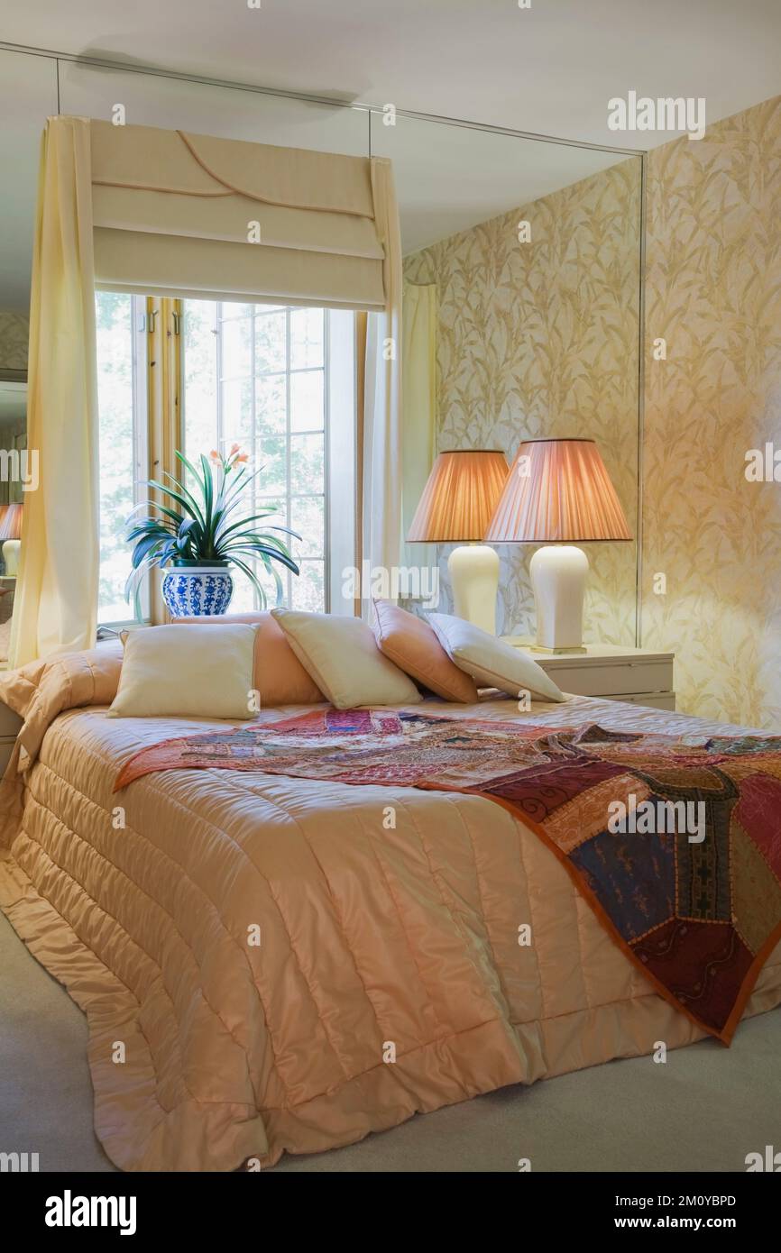 King size bed in master bedroom with large wall mirror inside mixed ...