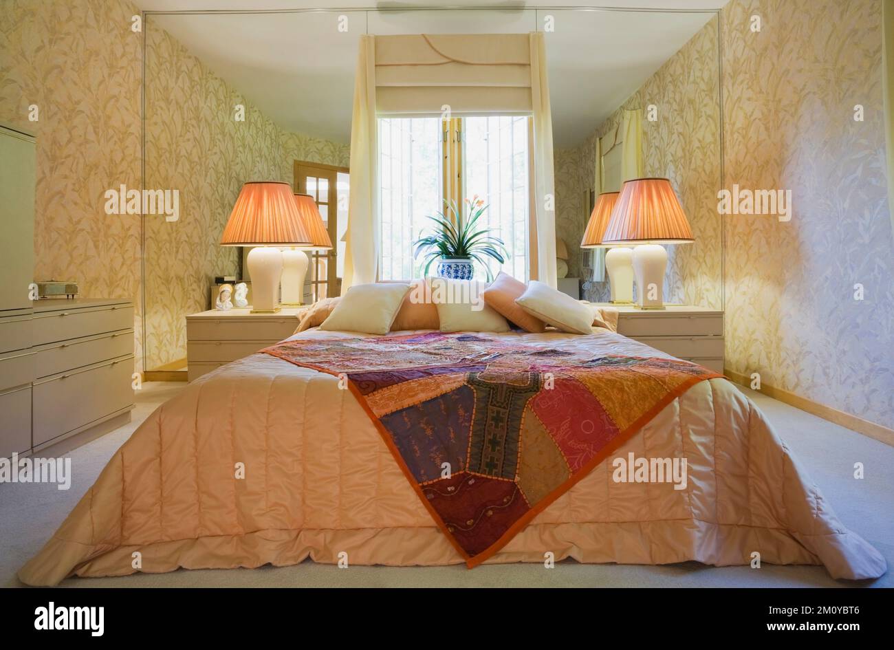 King size bed in master bedroom with large wall mirror inside mixed ...