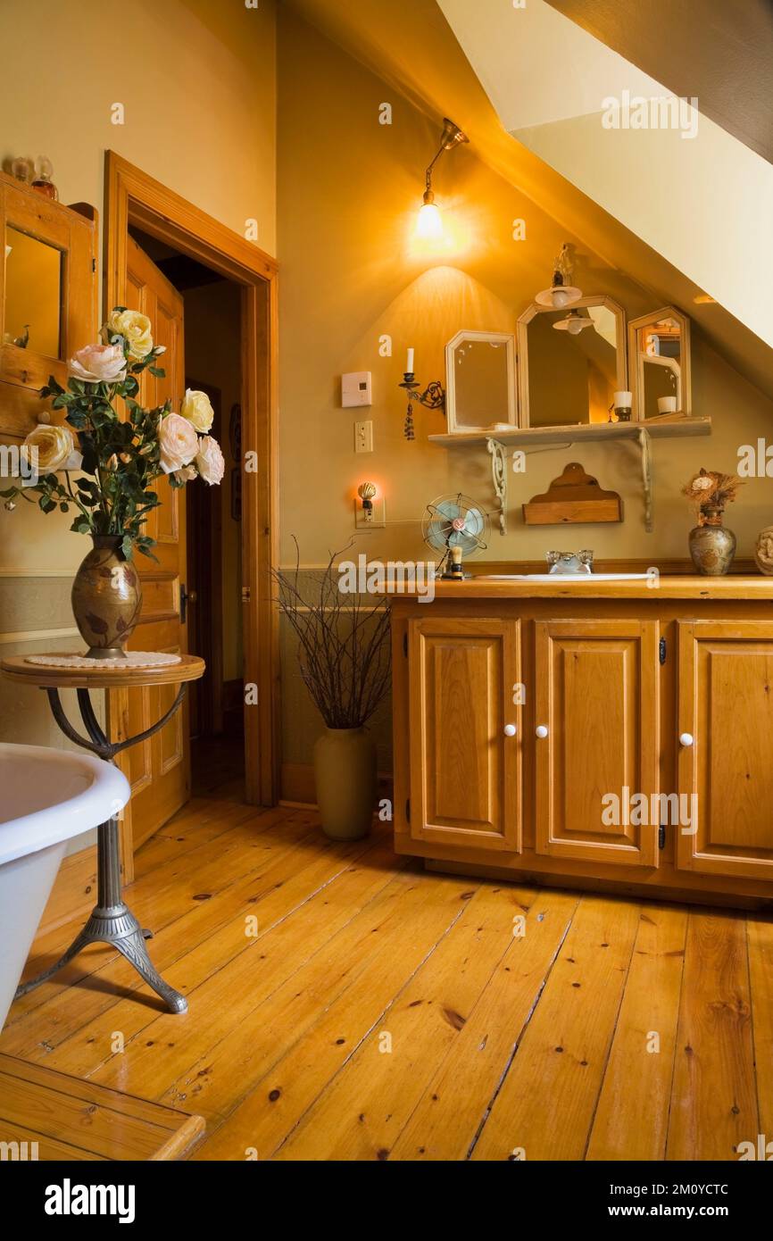 Antique wooden vanity and mirrors on shelf in rustic bathroom inside ...