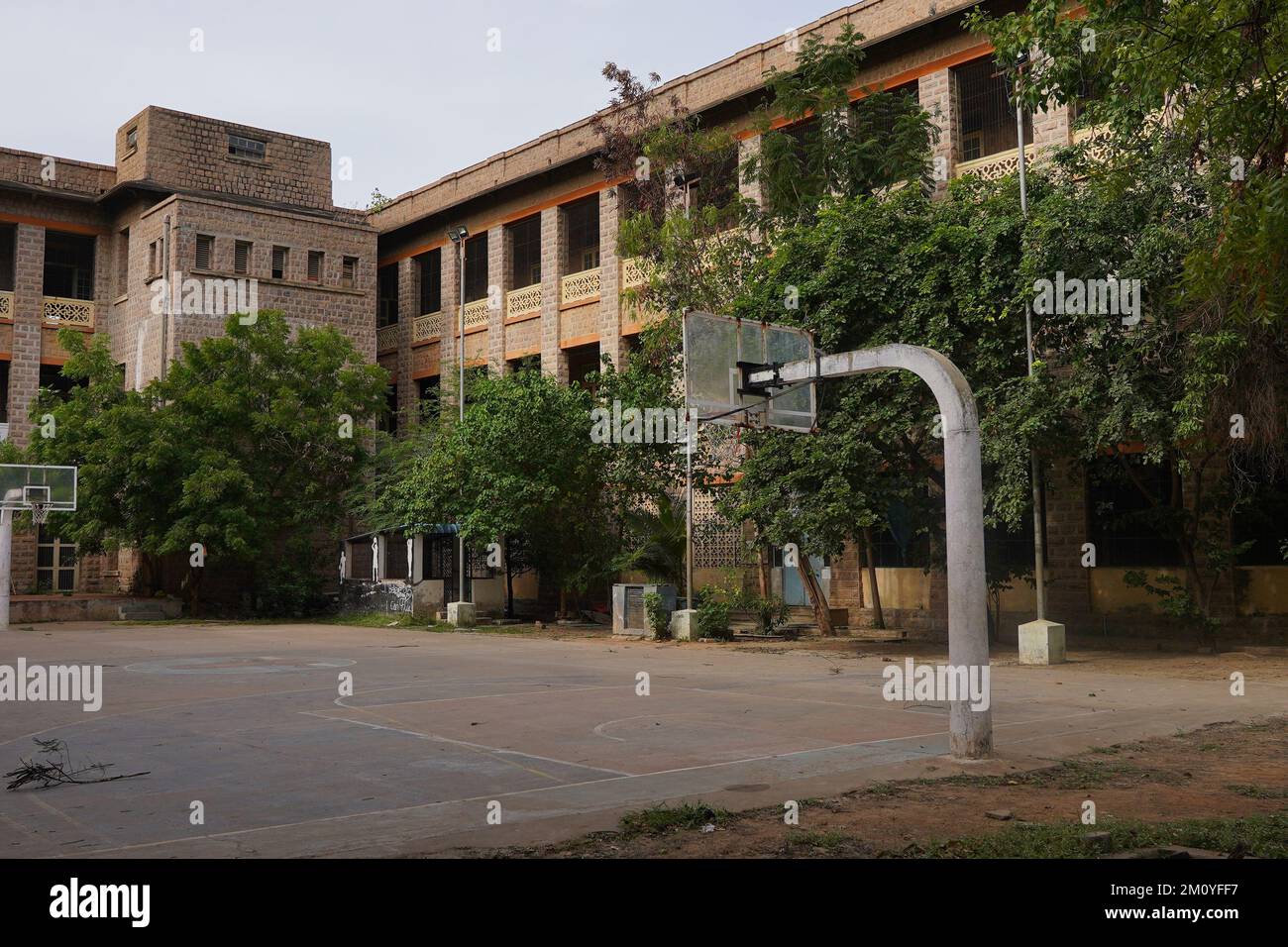 old vintage stone building with basket ball court Stock Photo - Alamy