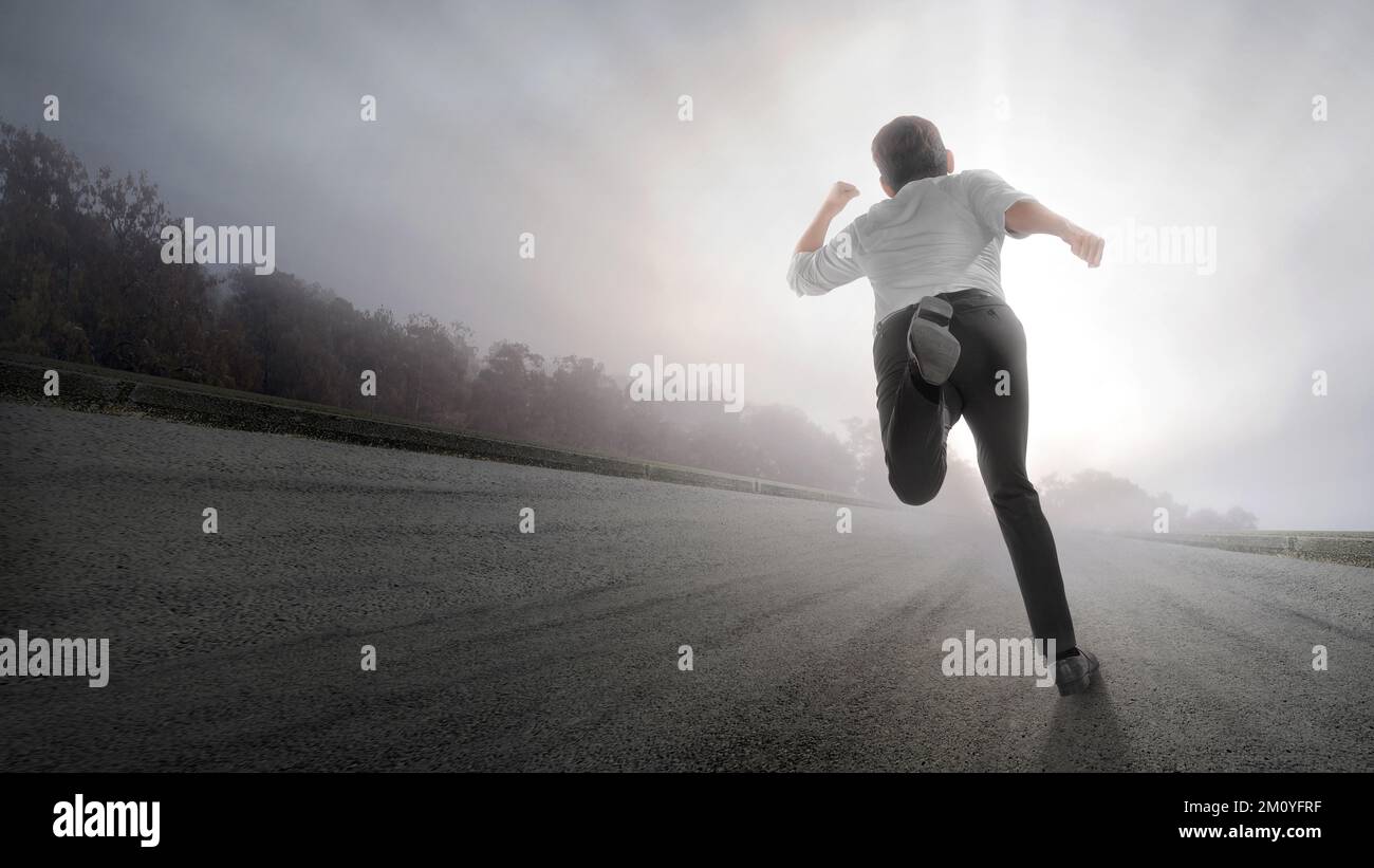 Rear view of Asian businessman running on the street Stock Photo - Alamy