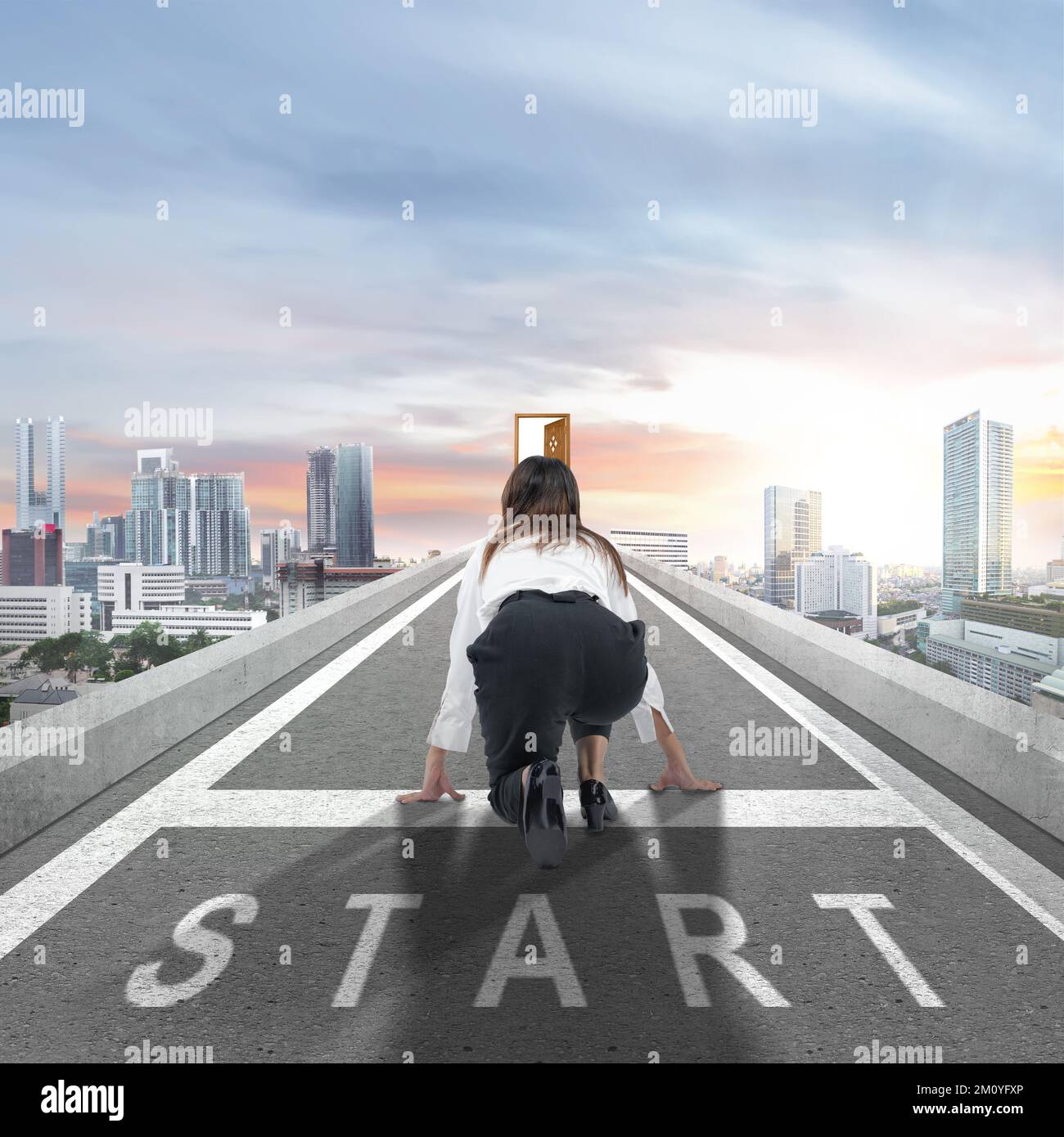 Rear view of Asian businesswoman in start position ready to run on the ...