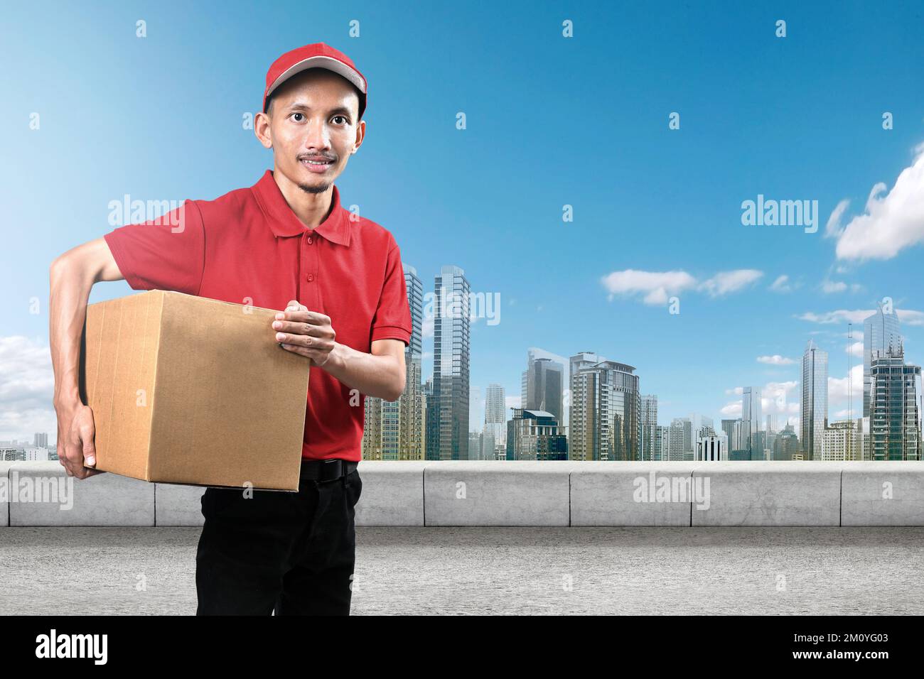 Parcel delivery man with a hat carrying a package in the city Stock ...