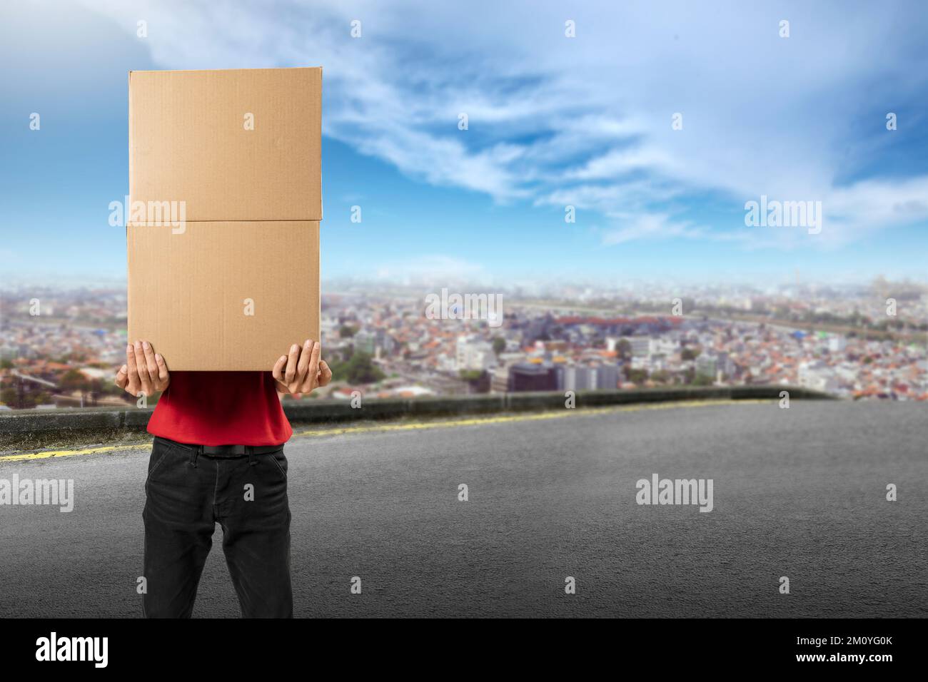 Parcel delivery man with a hat carrying a package in the city Stock ...