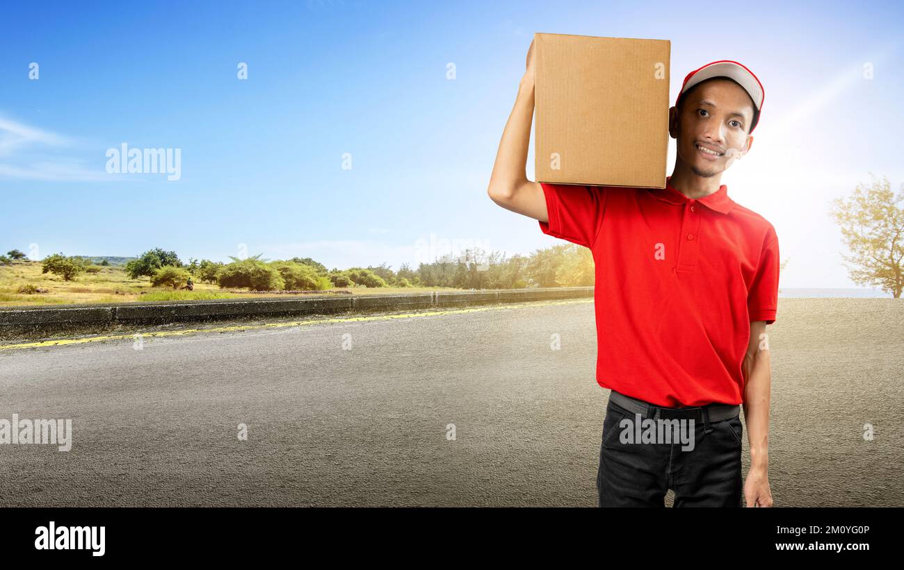 Parcel delivery man with a hat carrying a package in the city Stock ...