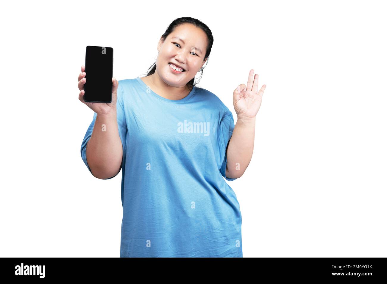 Asian fat overweight woman holding a mobile phone and showing an empty ...