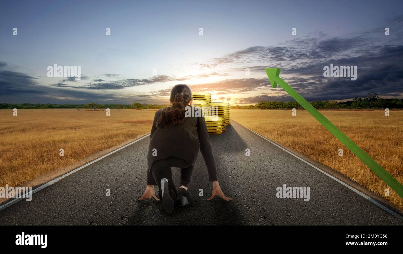 Rear view of Asian businesswoman in start position ready to run on the ...