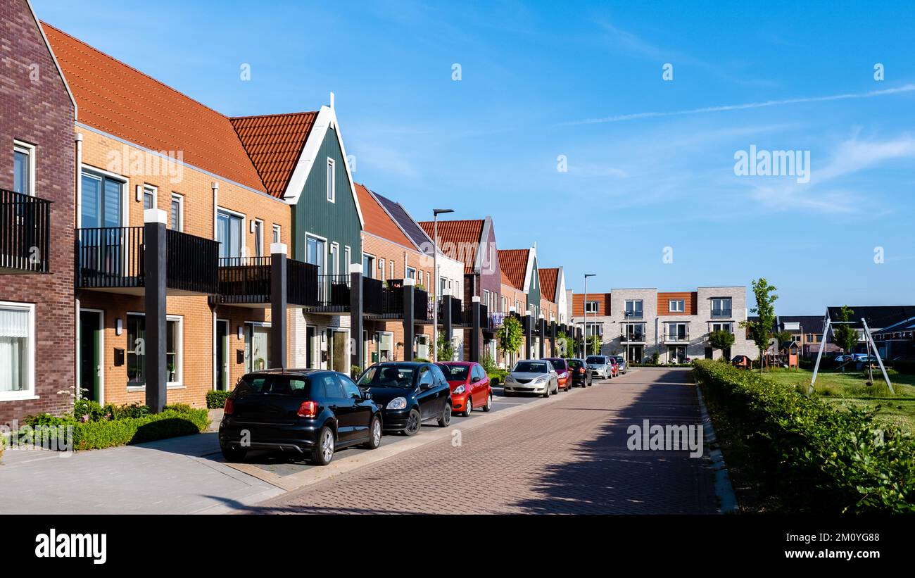 Dutch Suburban area with a row of modern family houses, newly build ...