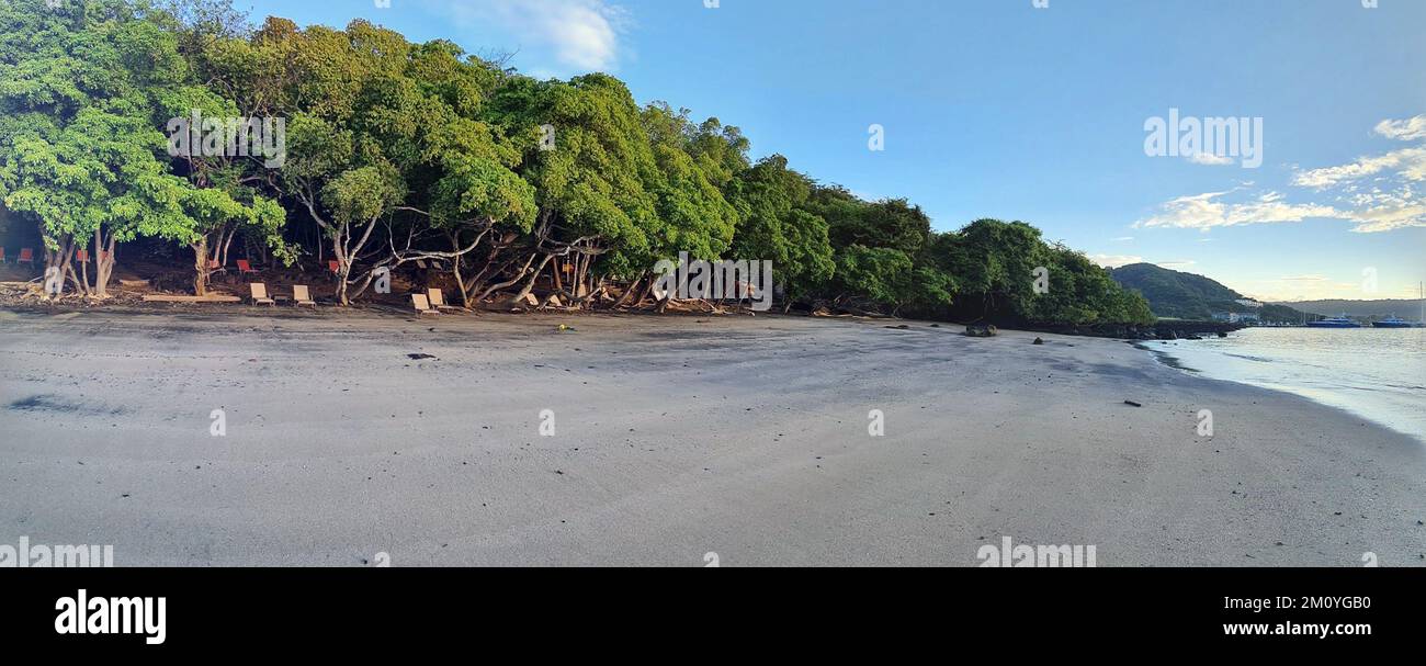a sandy beach next to a body of water Stock Photo - Alamy