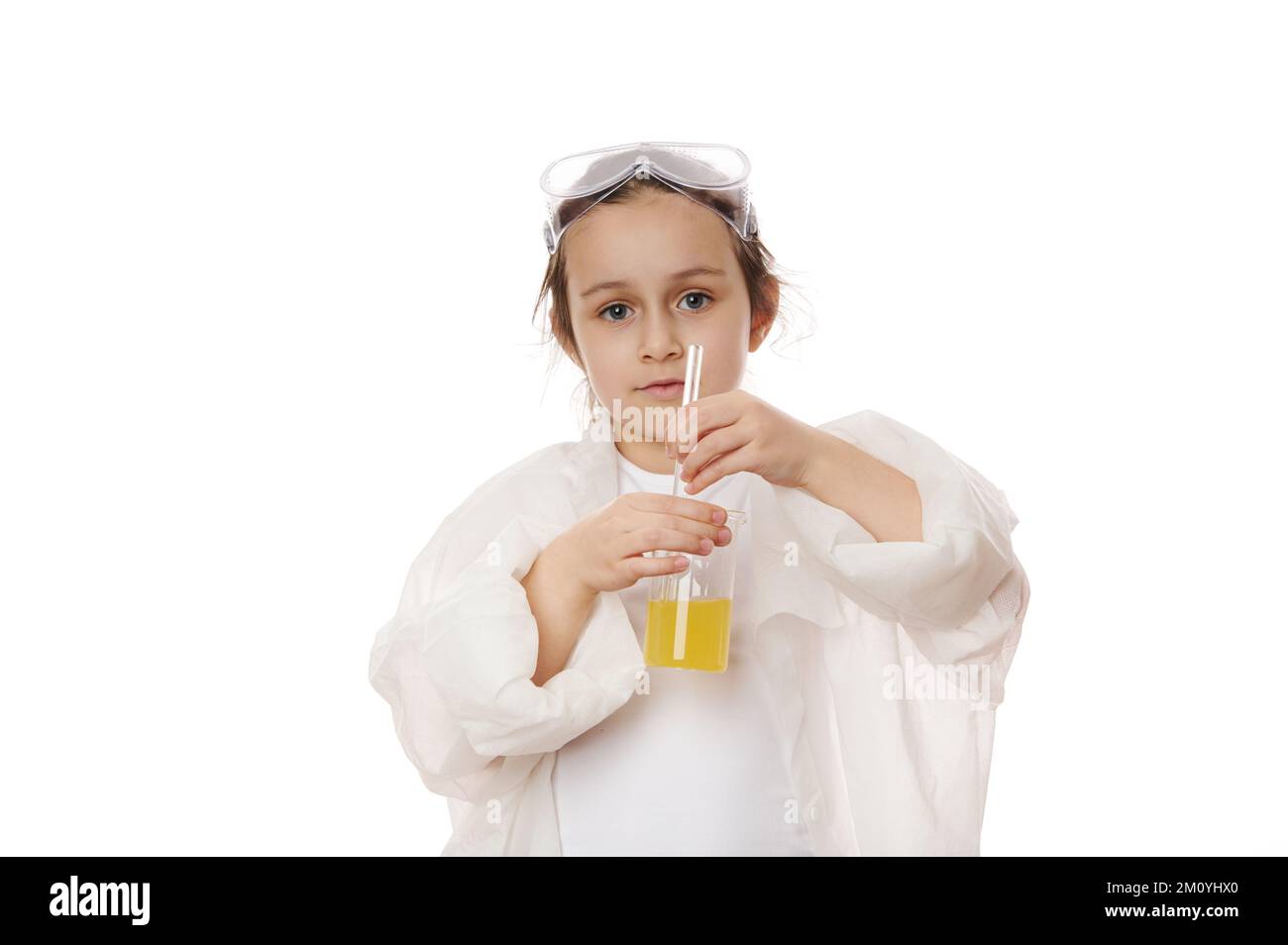 Primary school student, little girl in lab coat, using laboratory glass ...