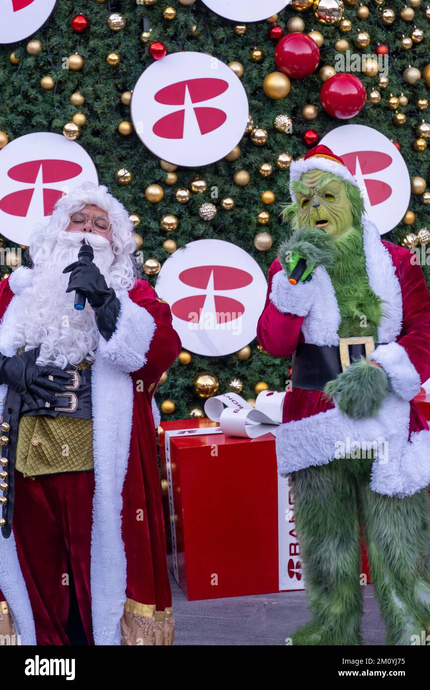 the grinch singing and dancing behind a christmas tree with big ...