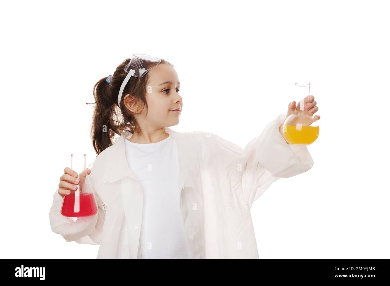 Young future chemist scientist, holding laboratory flasks and watching ...