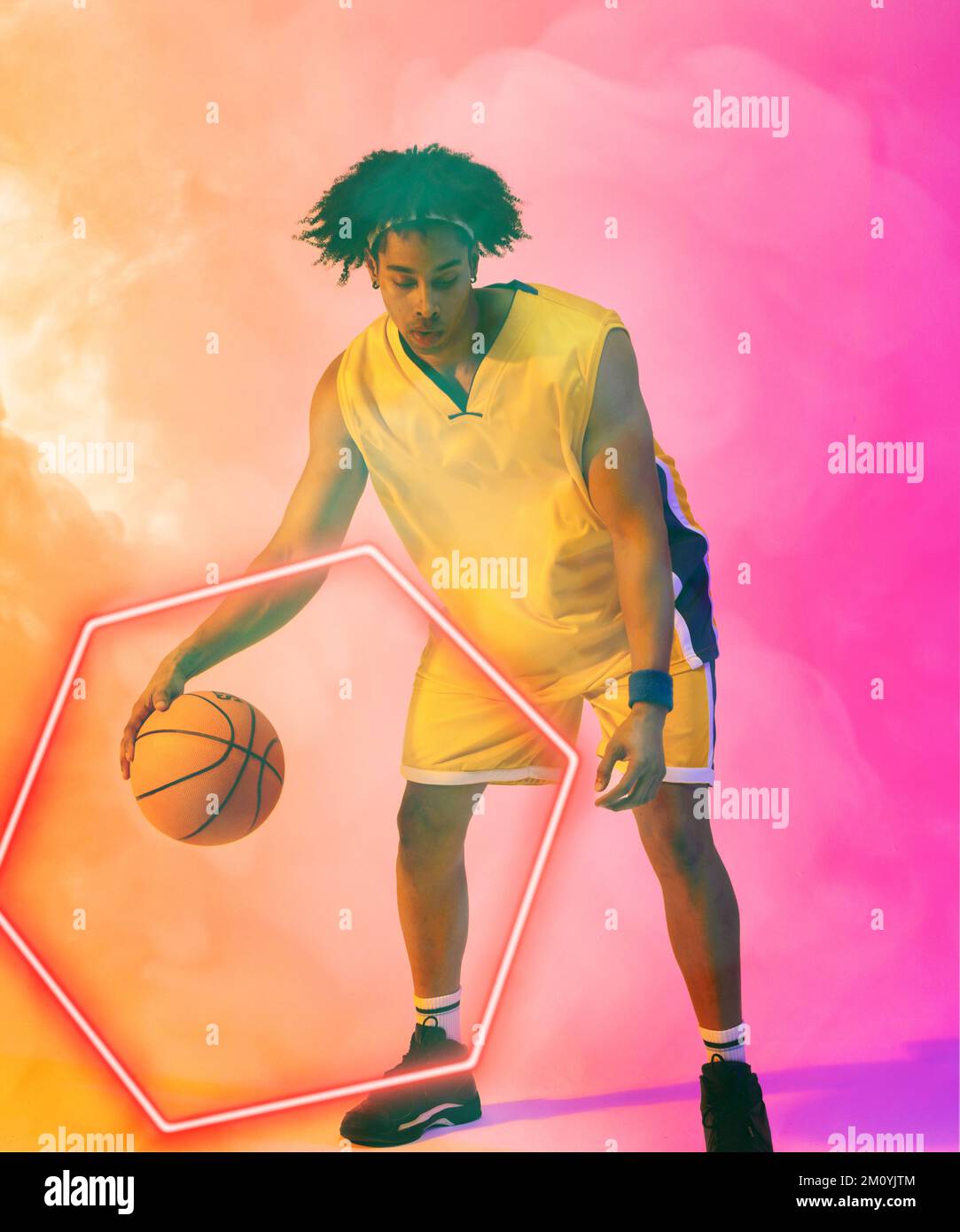 Composite of biracial male player dribbling basketball by glowing ...