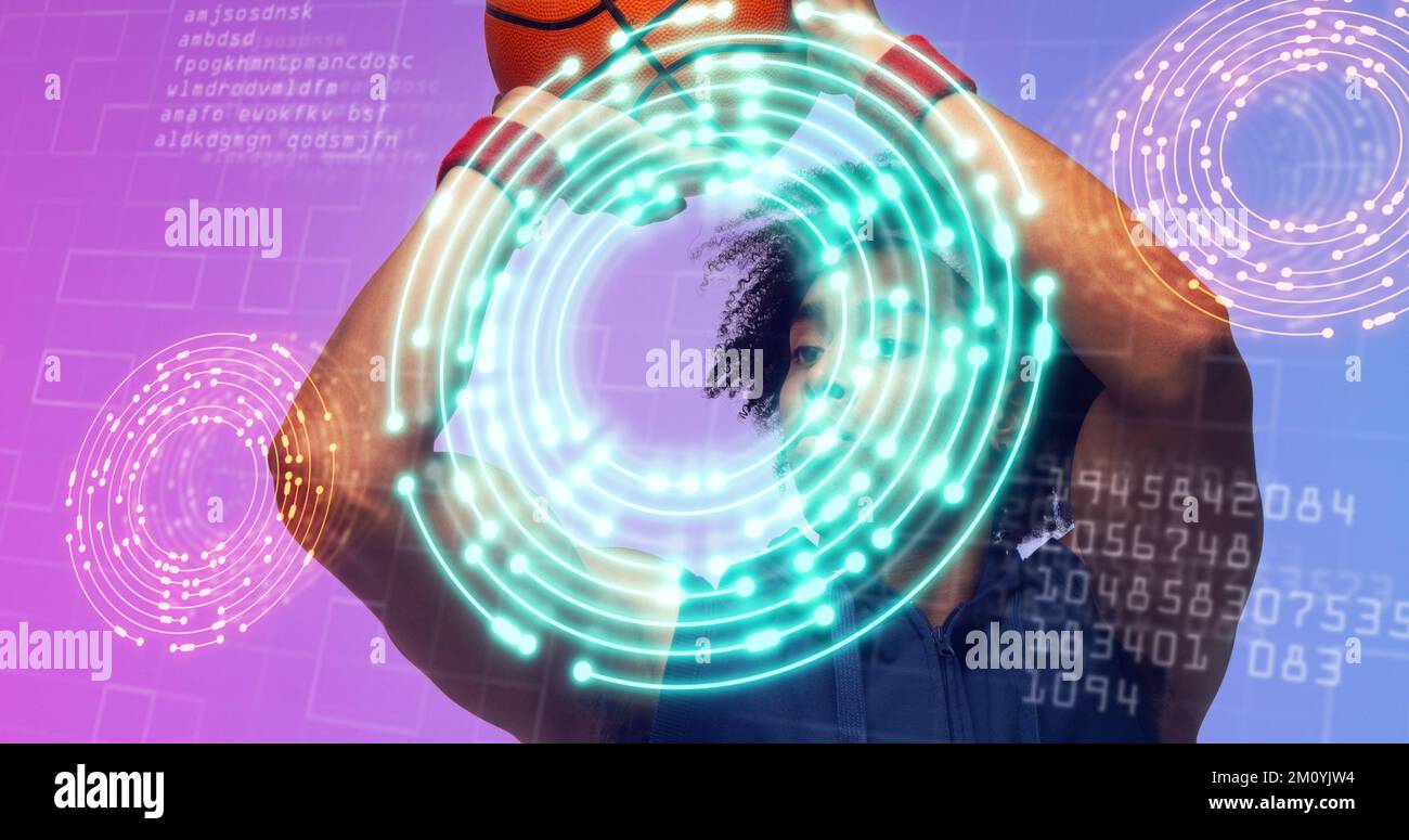 Biracial male player taking shoe with basketball over illuminated ...