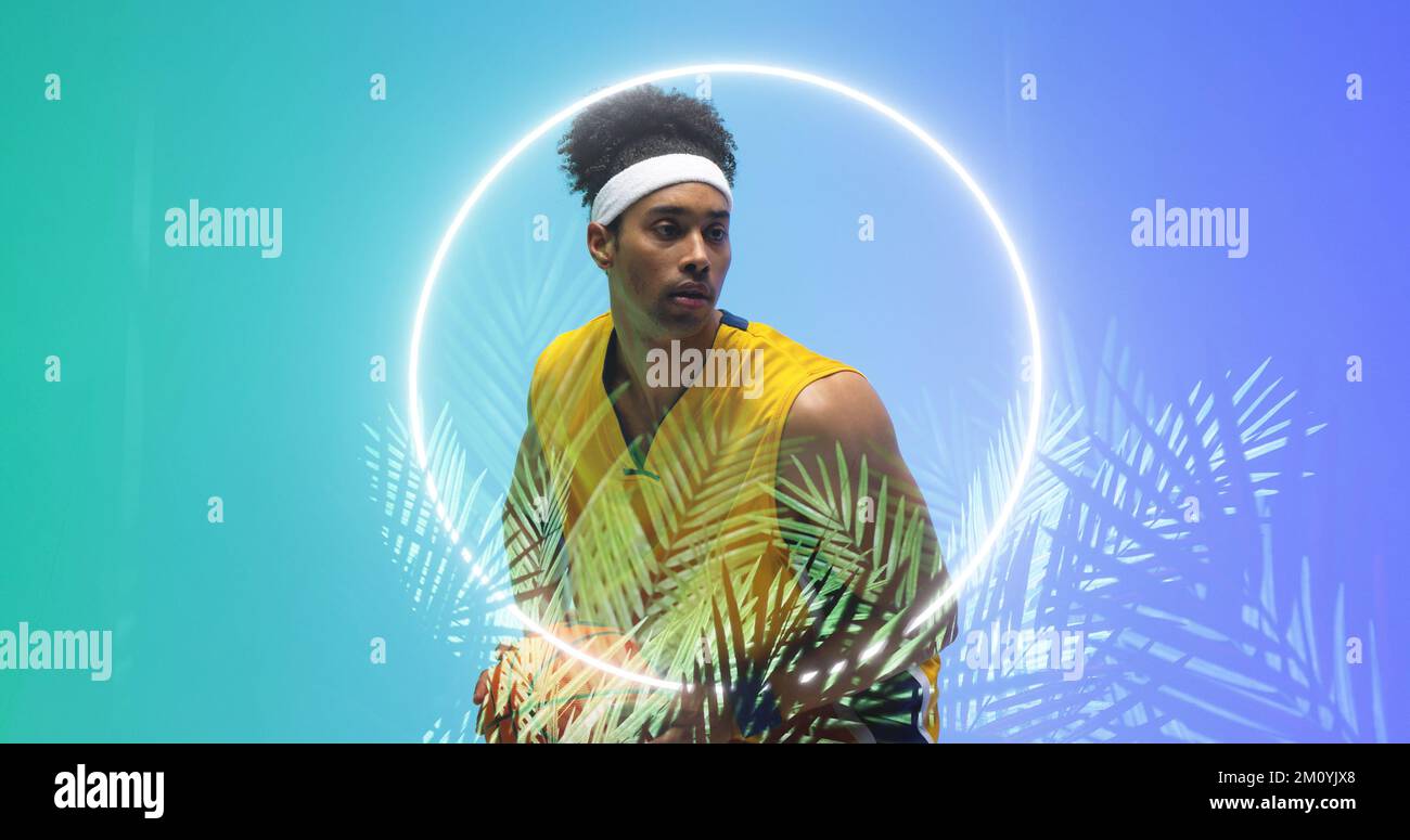 Composite of biracial basketball player looking away by illuminated ...